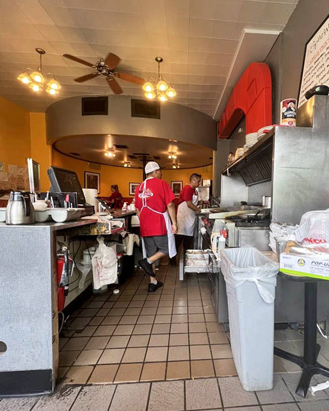The counter offers front-row seats to the breakfast theater, where blue stools await solo diners and coffee refills flow with generous abandon.