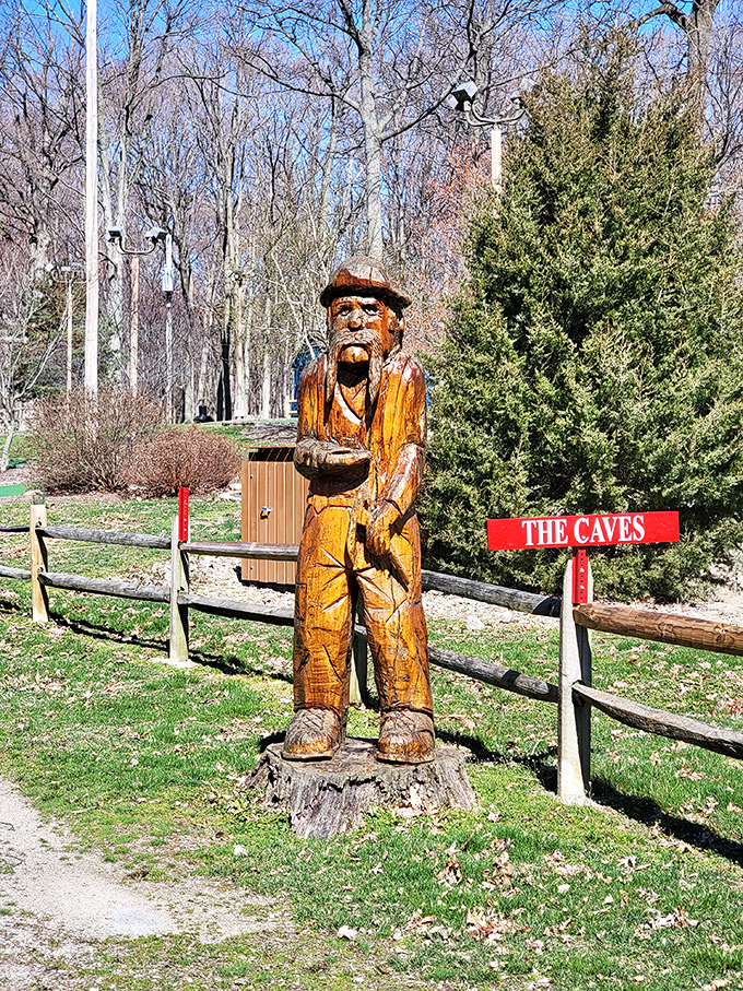 This wooden sentinel stands guard at the path to the caves, his carved face having witnessed decades of wide-eyed visitors.