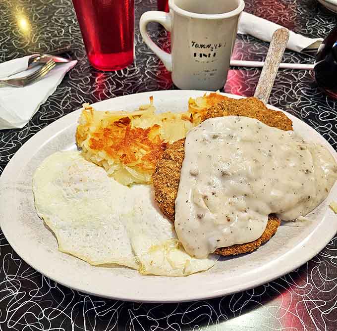 Country fried steak smothered in pepper-flecked gravy &ndash; comfort food that hugs your soul while challenging your belt notch.
