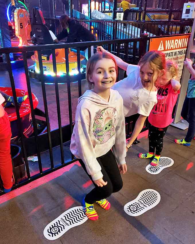 Young adventurers strategize their next move, their faces illuminated by both the colorful lights and the pure excitement of unlimited possibilities.