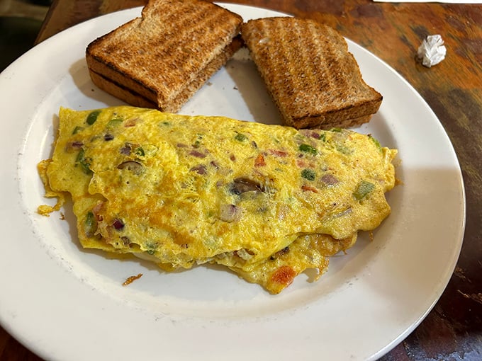 This isn't just any omelet &ndash; it's a vegetable delivery system disguised as breakfast, paired with toast that's actually been buttered.
