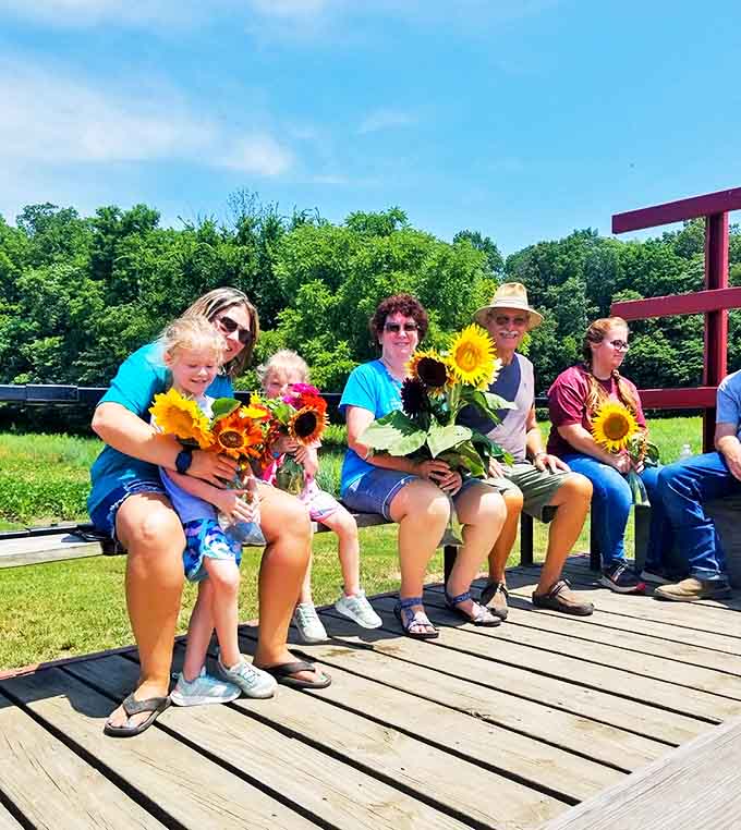 Multi-generational memories in the making as this wagon full of joy-riders proves sunflower appreciation knows no age limits.