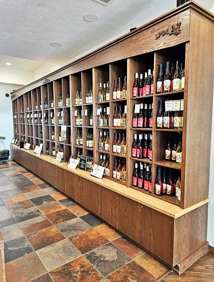 Wine Display Shelf: A library of liquid stories &ndash; each bottle on these rustic wooden shelves represents a chapter in Michigan's impressive winemaking saga.