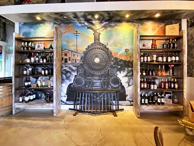 A stunning locomotive mural anchors this impressive wine collection, hinting at evening gatherings where coffee gives way to cabernet.