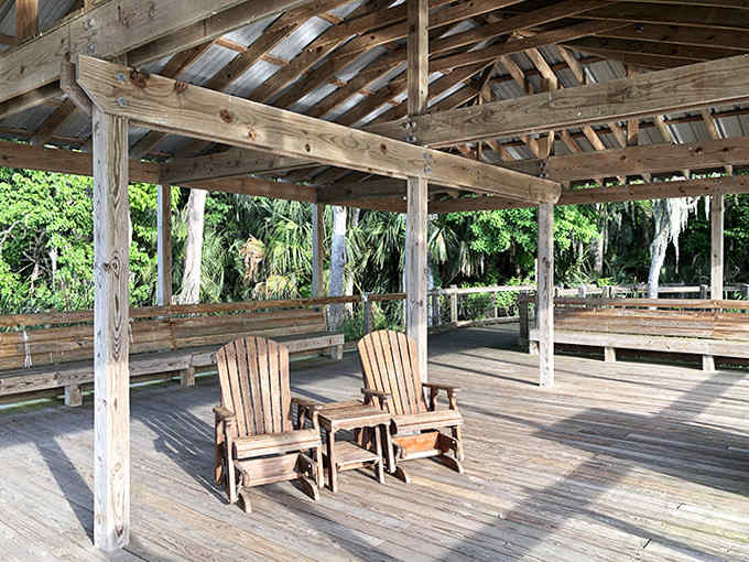 Two rocking chairs sit in conversation on this weathered pavilion, waiting for visitors to pause and appreciate the view.