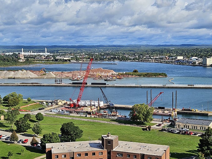 Aerial views reveal how the St. Marys River shapes everything, with the city sprawling along its banks like civilization has always done near water.