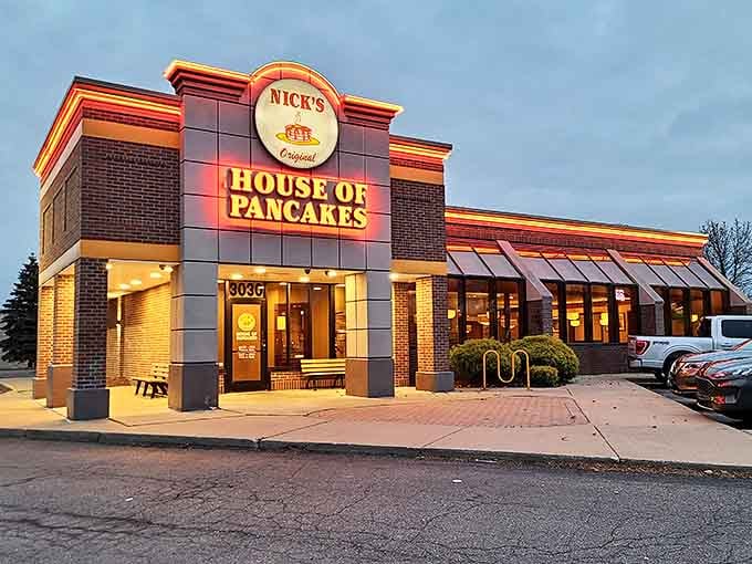 As darkness falls, the illuminated sign serves as a beacon for those seeking pancake perfection at any hour.