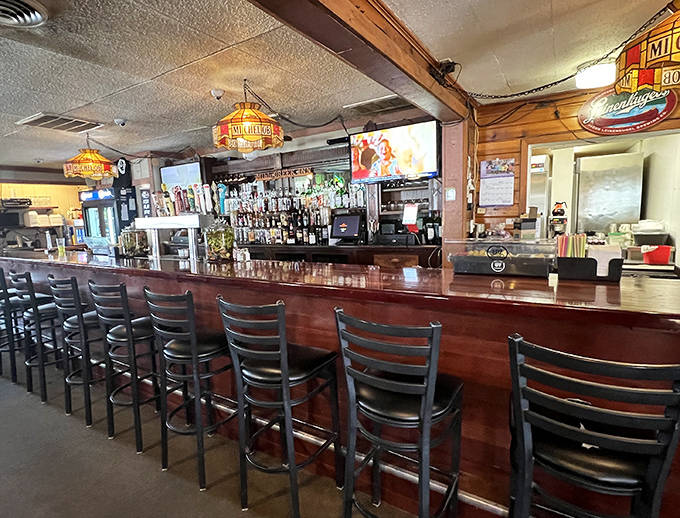 The bar stretches invitingly along one wall, where friendly faces perch on stools that have supported generations of local posteriors.
