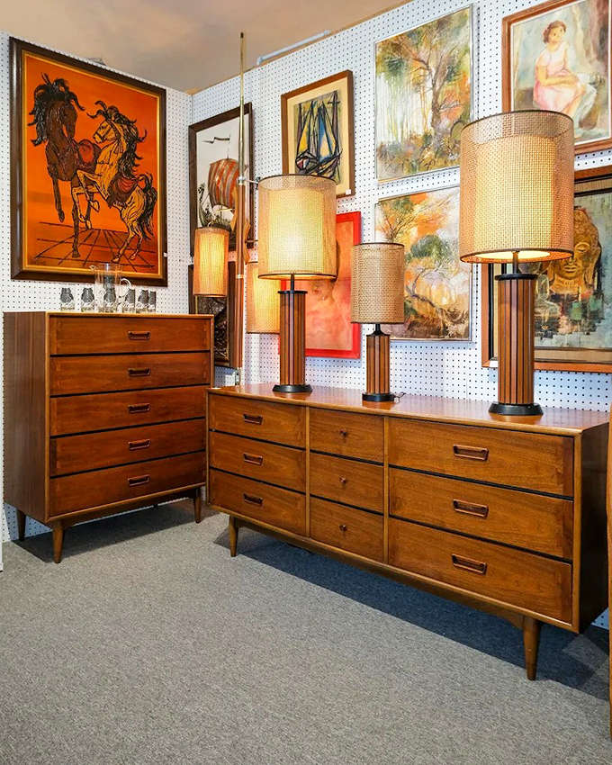 These walnut dressers with matching lamps aren't reproductions &ndash; they're authentic mid-century pieces that survived decades of changing tastes.