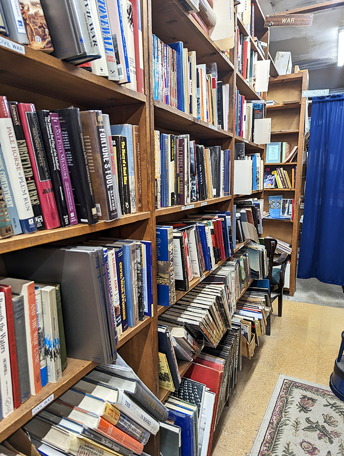 Books stacked in organized chaos create that perfect bookstore aesthetic &ndash; overwhelming yet somehow making complete sense to bibliophiles.