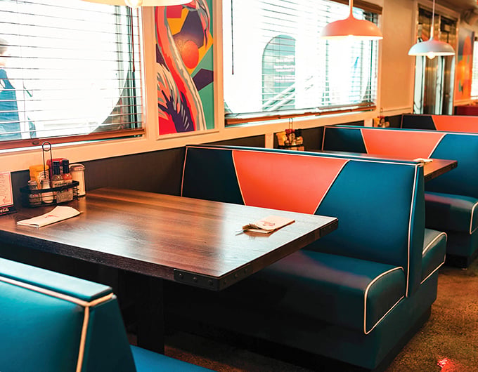 These booths aren't just seating&mdash;they're front-row tickets to the theater of American dining. The teal and coral color scheme screams "Florida" without saying a word.
