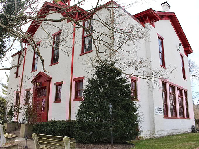 The pristine white exterior with red accents stands as a testament to preservation done right in rural Ohio.