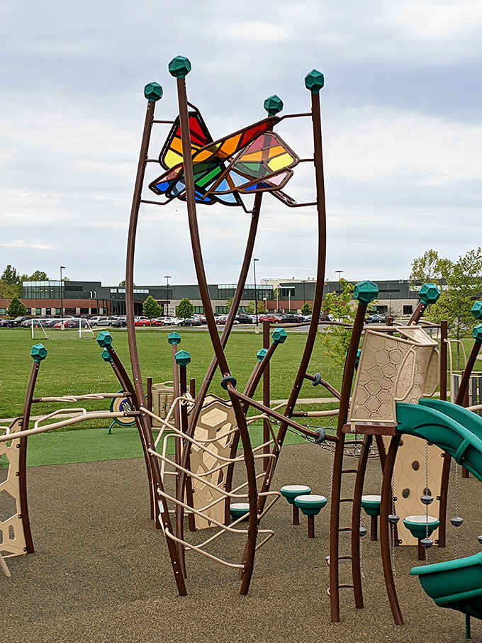 Art meets play in this stunning butterfly installation. Translucent panels catch sunlight, creating colorful shadows that dance across the playground.