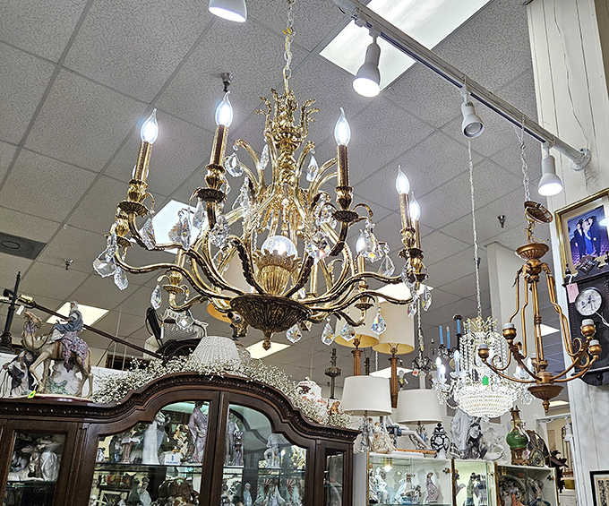 Chandeliers that once illuminated grand ballrooms now compete for attention, each crystal prism whispering tales of elegant soir&eacute;es.