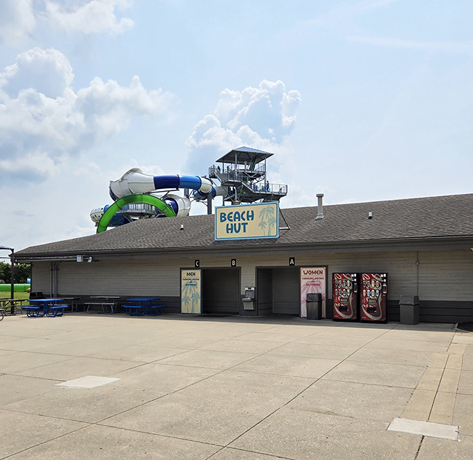 A quiet corner of the amusement park&mdash;where the Beach Hut rests under sunny skies, watching over the towering slides ahead.&rdquo;