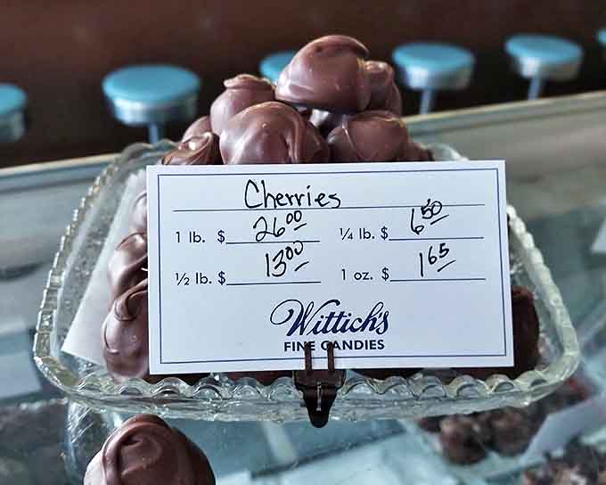 These chocolate-covered cherries sit like jewels in their crystal dish, each promising that perfect burst of sweet-tart syrup when you bite through the handcrafted shell.