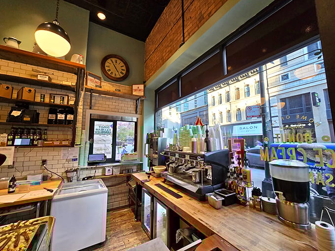 The coffee bar gleams with promise, where baristas transform simple beans into the perfect companion for your chosen donut adventure.