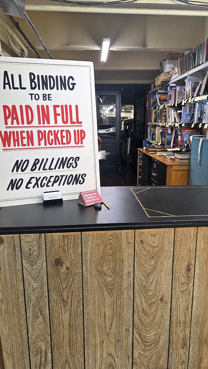 "All binding to be paid in full" – the no-nonsense sign reflects the store's old-school approach to business, refreshingly direct in our era of fine print.