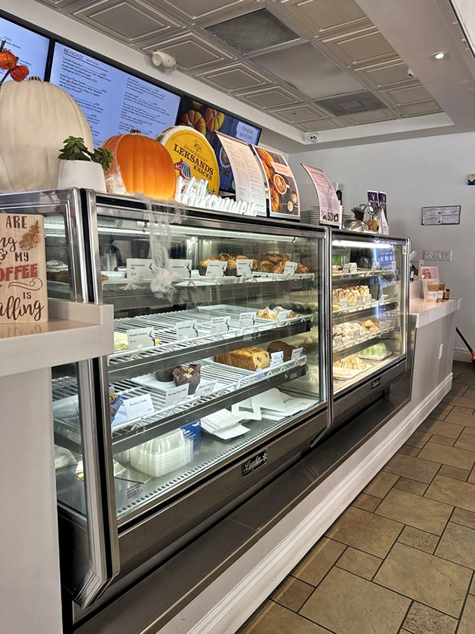 Counter display: A glass case of temptation showcasing pastries and treats that make willpower crumble faster than their flaky crusts.