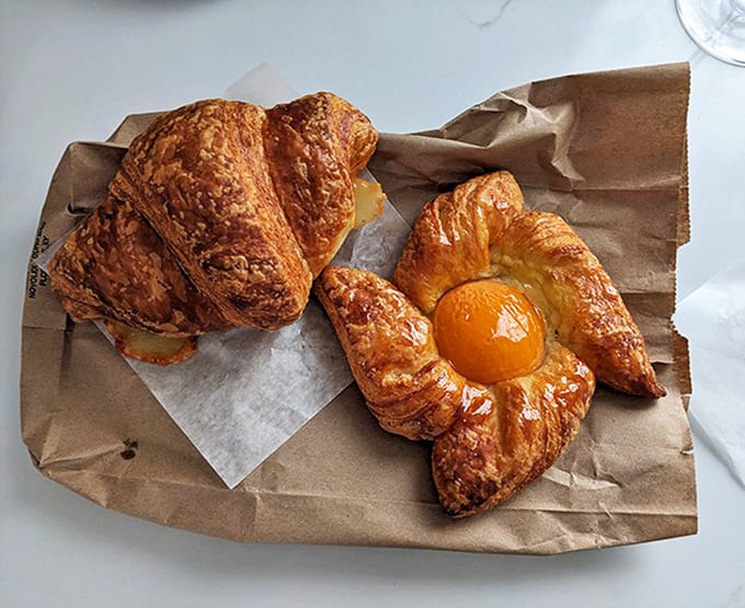 A ham and cheese croissant alongside a peach Danish represents the kind of tough decisions you'll face here daily.