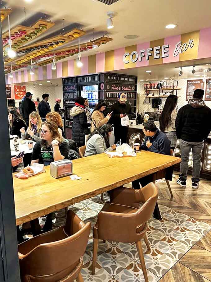 The bustling interior shows Stan's democratic appeal &ndash; where suits and sweatpants unite in the universal language of donut appreciation.