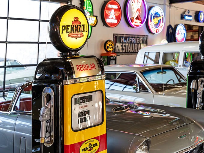 Vintage Pennzoil pumps stand sentinel among classic cars, their analog displays forever frozen at prices that would make today's drivers weep with nostalgia.