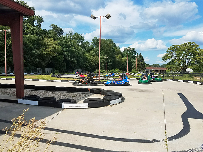Go-karts zoom around the track, where everyday parents transform into competitive speed demons behind tiny steering wheels.