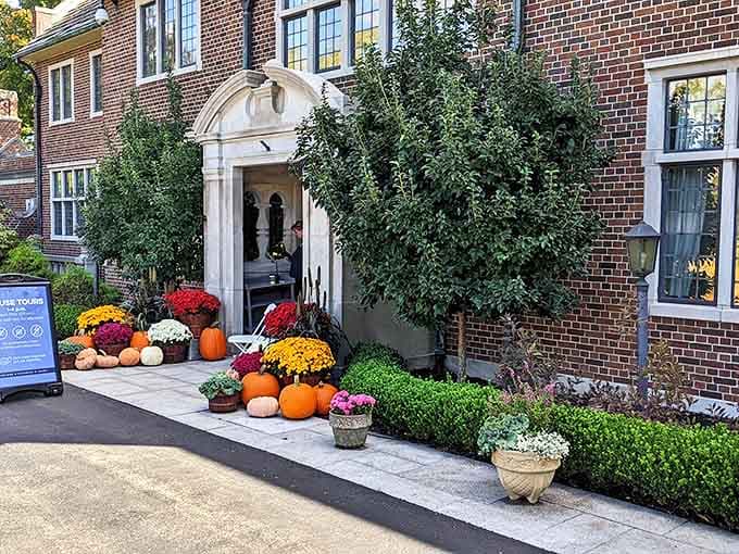 Fall pumpkins and mums create a harvest welcome at the mansion entrance, proving Applewood celebrates Michigan's seasons with natural flair.