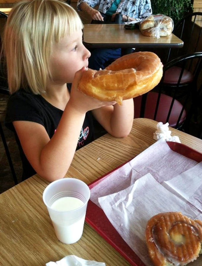 The joy of childhood captured in one giant donut, proving some pleasures truly are timeless.