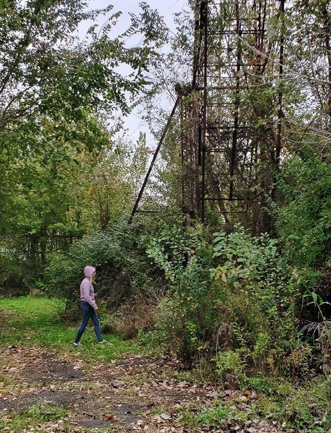 Scale becomes apparent when humans stand beside these massive structures&mdash;this ferris wheel frame towers like an industrial art installation.