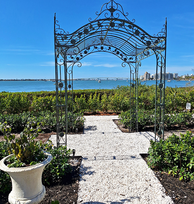 Scenic View: An ornate iron archway frames the sparkling waters of Sarasota Bay, proving that sometimes the best picture frames aren't found in galleries.