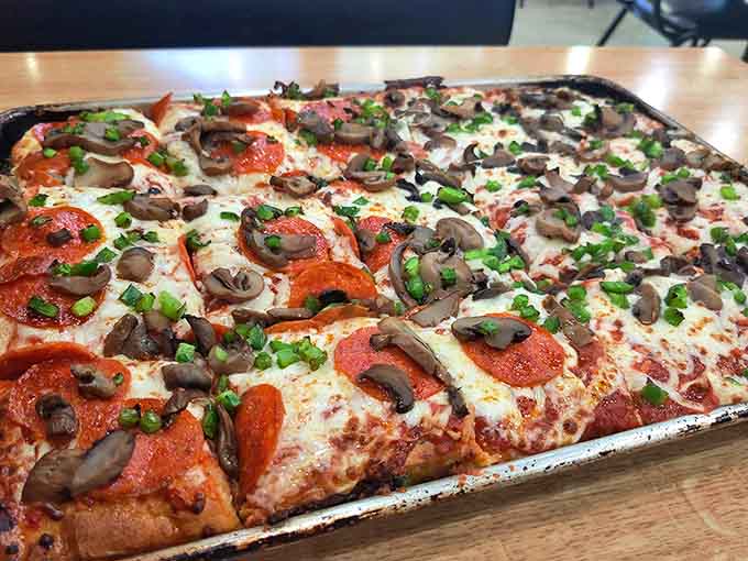 Sheet pan pizza: The rectangular wonder! This Detroit-style creation with its crispy cheese edges might just start a regional pizza loyalty crisis.