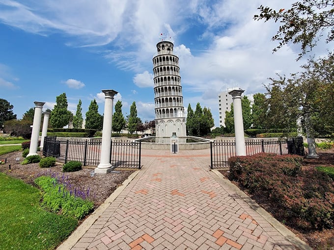 Elegant columns and wrought iron fencing create a formal entrance to the tower plaza, inviting visitors to step into this slice of Italy.