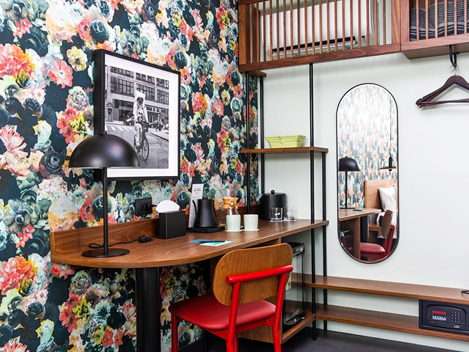 A thoughtfully designed workspace where the floral wallpaper somehow makes answering emails feel less like a chore.