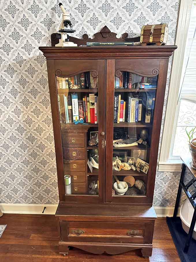 This Victorian cabinet doesn't just display treasures &ndash; it is one. Books, scientific instruments, and curiosities find perfect homes behind its glass-fronted doors.