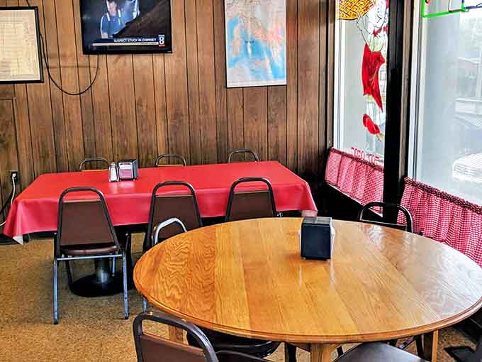 Simple tables with red tablecloths create that classic pizzeria vibe where conversations flow as freely as the soda refills.