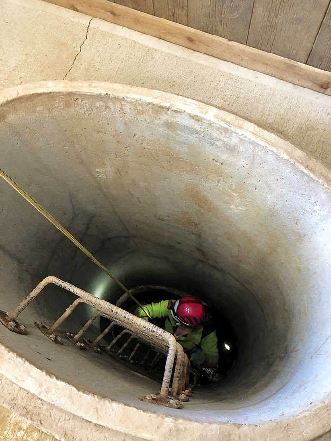 A cave explorer navigates the entrance shaft, the first step in a journey that travels both downward and backward in time.