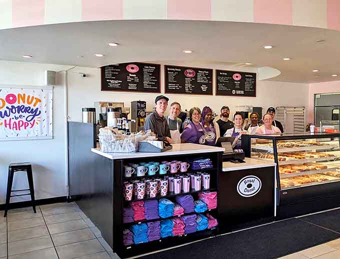 The heart of donut operations &ndash; where friendly faces and fresh pastries create the perfect morning alchemy.