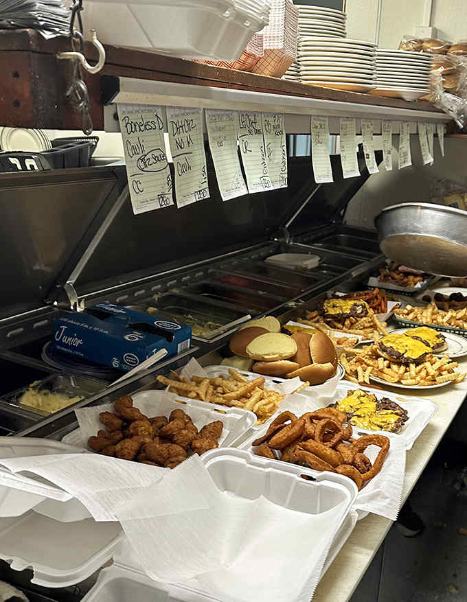 The kitchen command center where burger magic happens &ndash; handwritten tickets, organized chaos, and decades of cooking wisdom in action.
