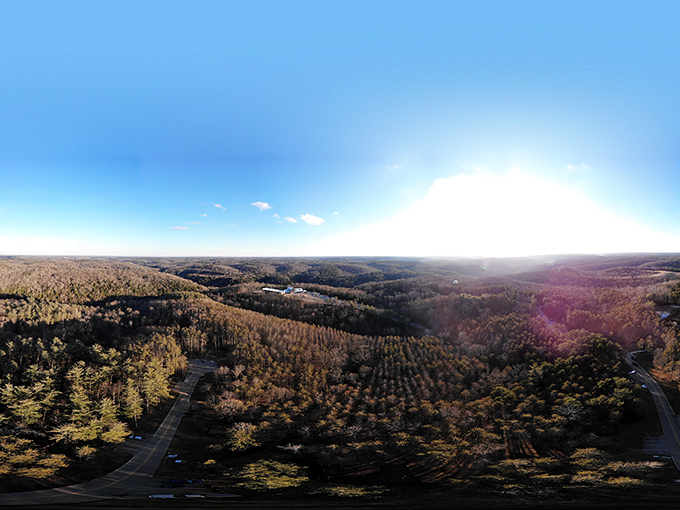 The aerial view reveals Hocking Hills' true scale &ndash; a vast green tapestry where our human footpaths are merely thin threads in nature's grand design.