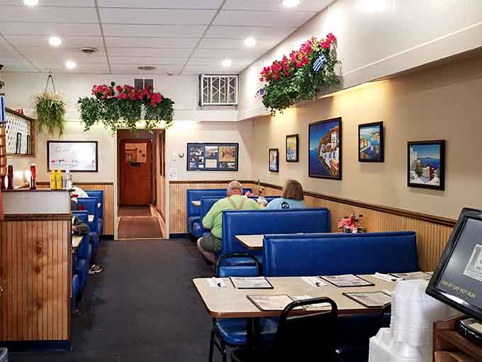 Comfortable seating and scenic Greek photography make every meal feel like a mini vacation from everyday life.