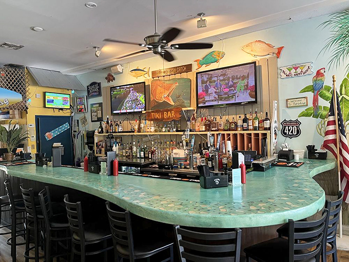 The tiki bar's aqua countertop mimics ocean waves, promising tropical concoctions strong enough to make mermaids sing.