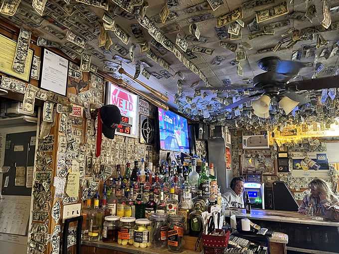 The bar's worn surface tells stories of countless elbows, spilled drinks, and conversations that stretched into the night.