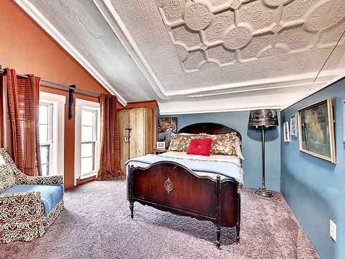 Blue walls and ornate ceilings create a heavenly sleep chamber where dreams are accompanied by architectural angels.
