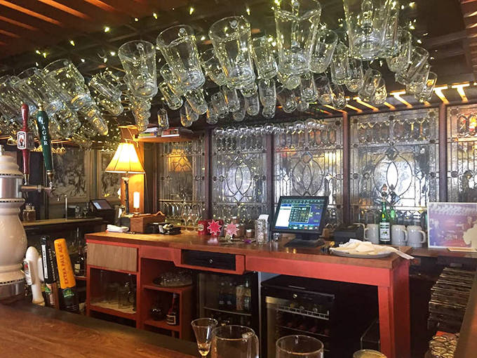 Gleaming glasses suspended above the wooden bar create a chandelier effect &ndash; liquid crystal waiting to be filled with Bavarian brews.