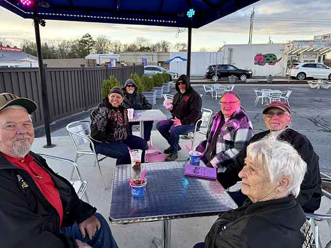 Families gathering under umbrellas, united by their love of custard and good company on warm evenings.