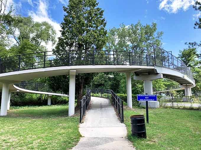 This elegant pedestrian bridge connects the practical to the playful, leading visitors from parking areas to picnic paradises beyond.