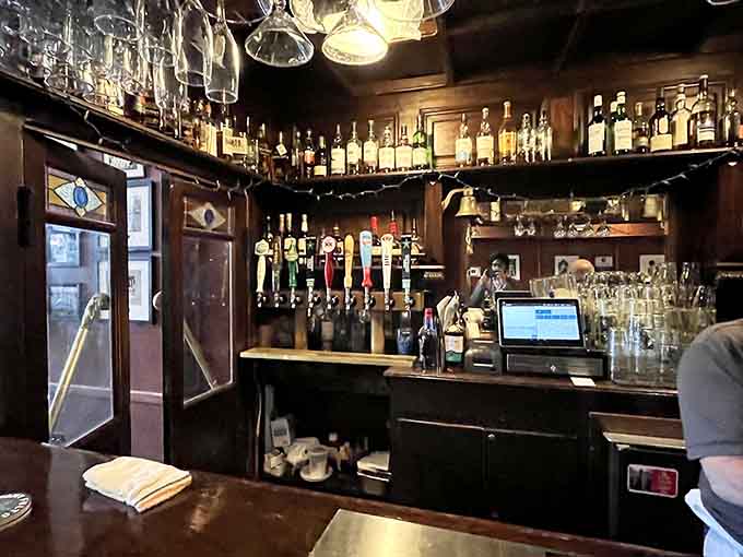 The bar area gleams with bottles and taps, ready to pour everything from traditional British ales to creative craft cocktails.