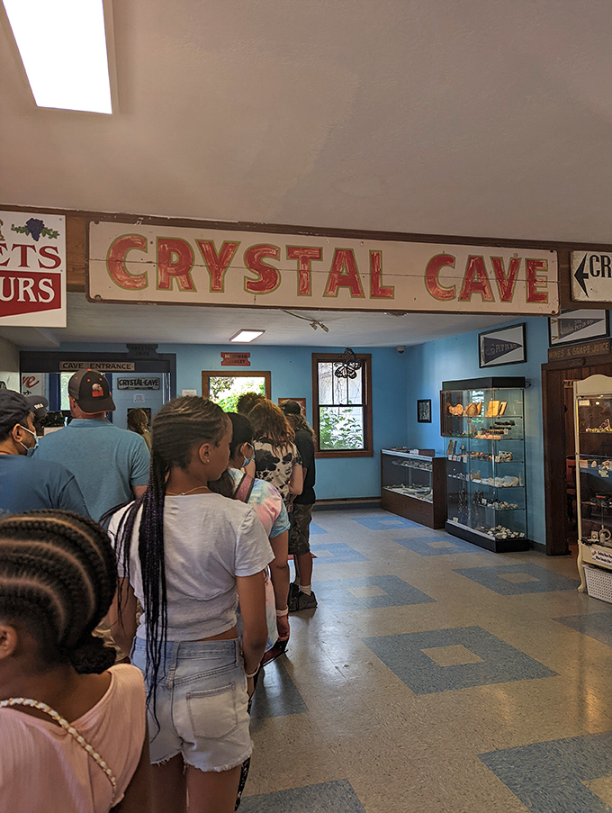 The anticipation builds as visitors queue beneath the vintage Crystal Cave sign, unaware of the subterranean spectacle awaiting them below.