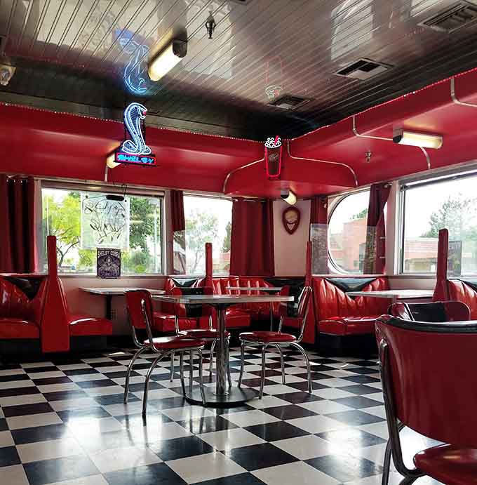 The dining room glows with neon and nostalgia, creating an atmosphere that makes every meal feel like a special occasion.